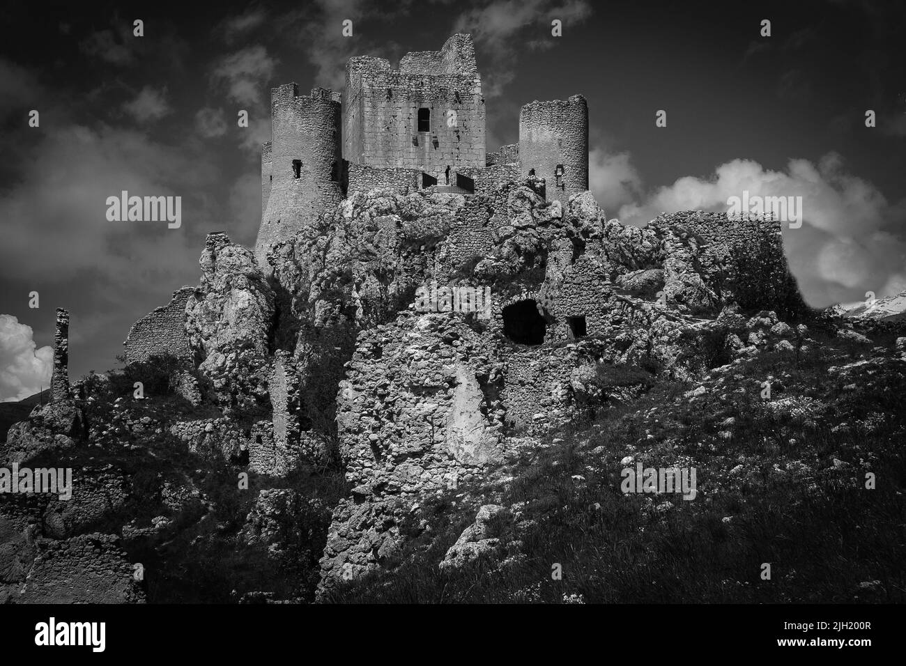 Black and white view of castle ruins on mountain top at Rocca Calascio, italian travel ...