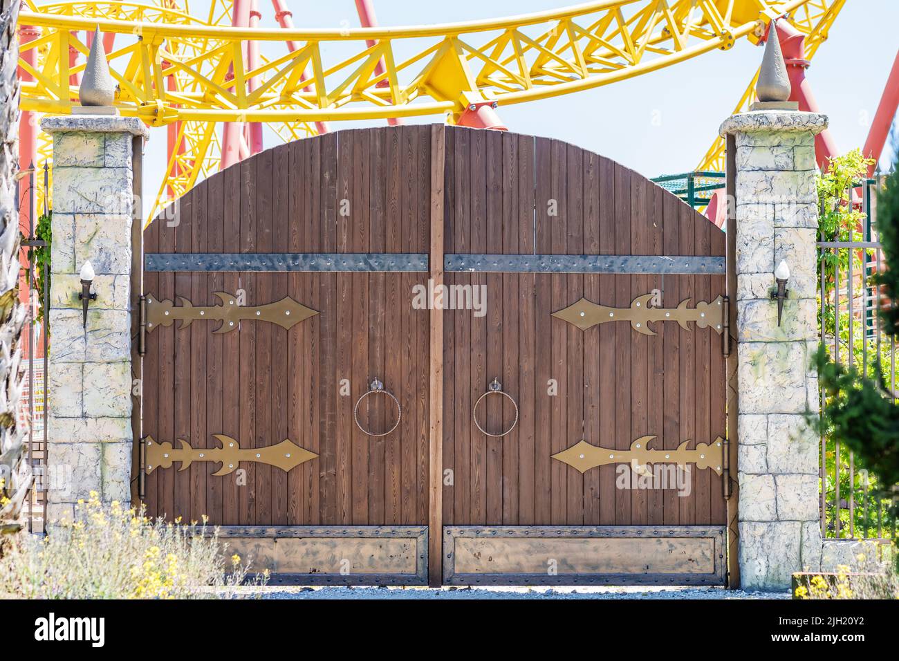 Wooden fabulous rounded gates in medieval style in an amusement park on ...