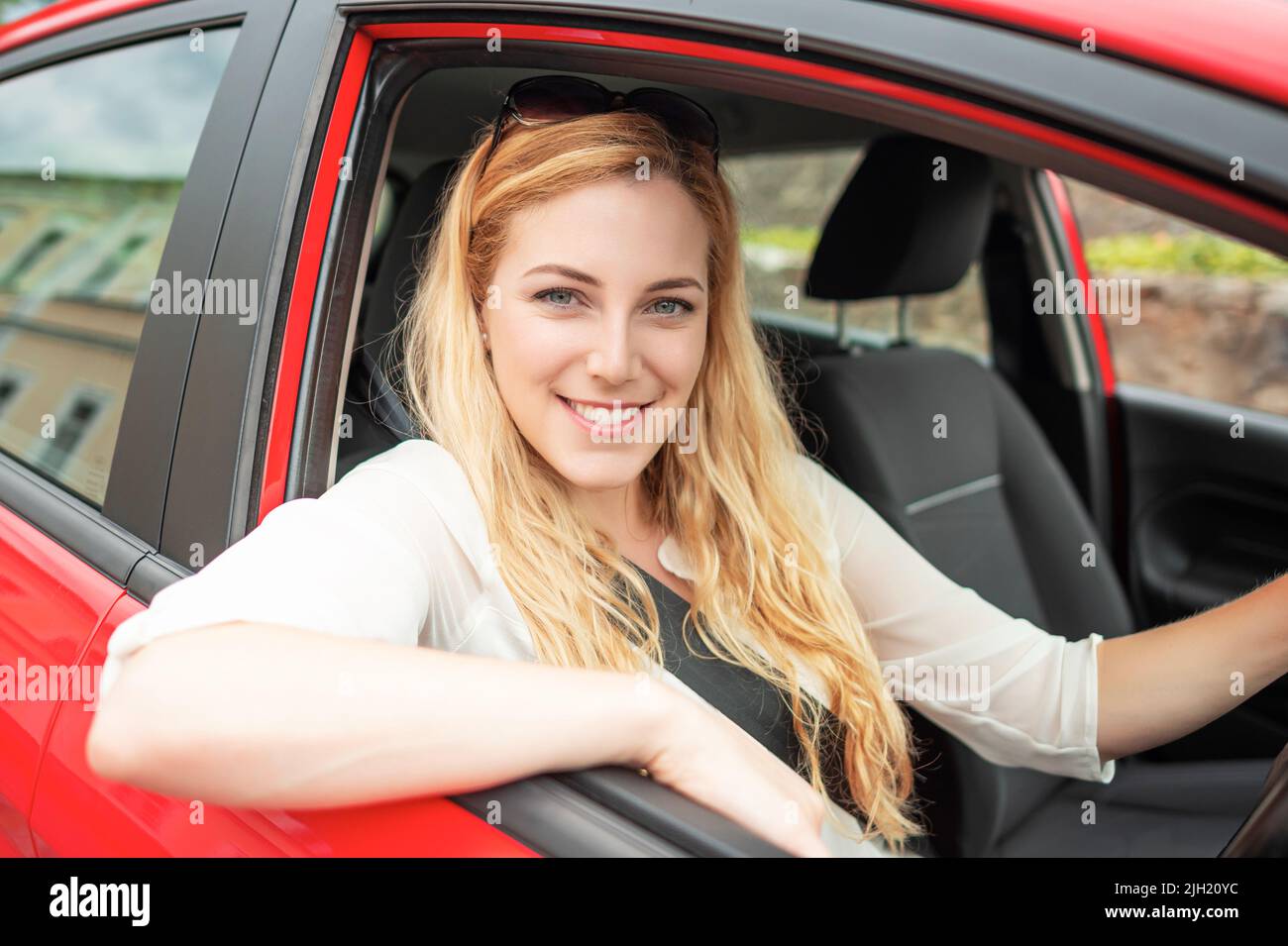 Beautiful blonde driving a car Stock Photo - Alamy