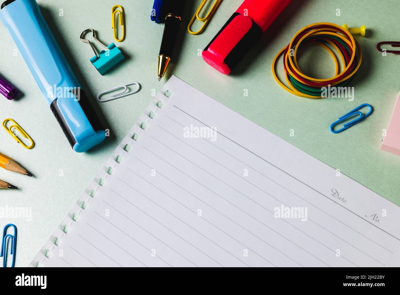 Composition of notebook with copy space and school tools on green ...