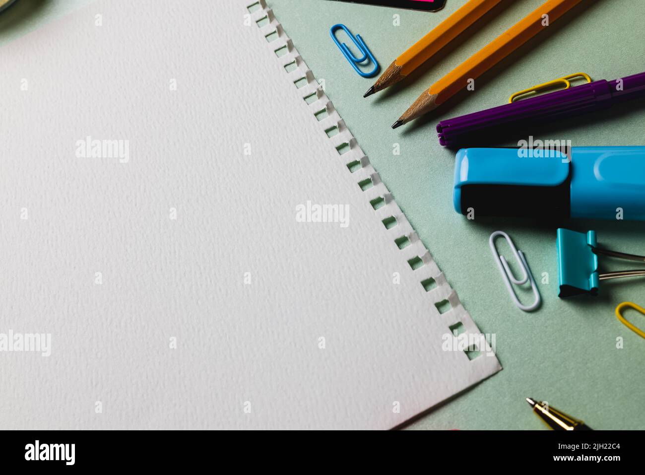 Composition of notebook with copy space and school tools on green ...