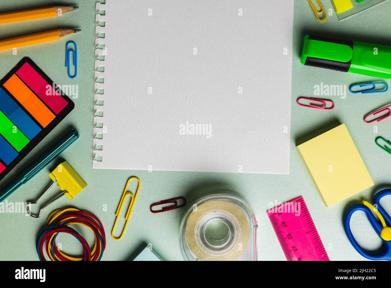 Composition of notebook with copy space and school tools on green ...