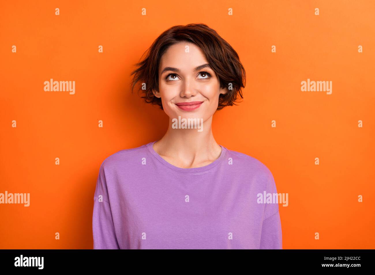 Photo of adorable thoughtful girl dressed purple pullover looking up ...
