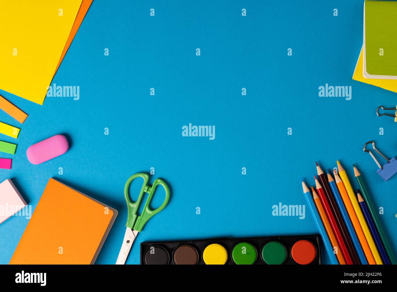 Composition of colorful school items with scissors and empty cards on ...