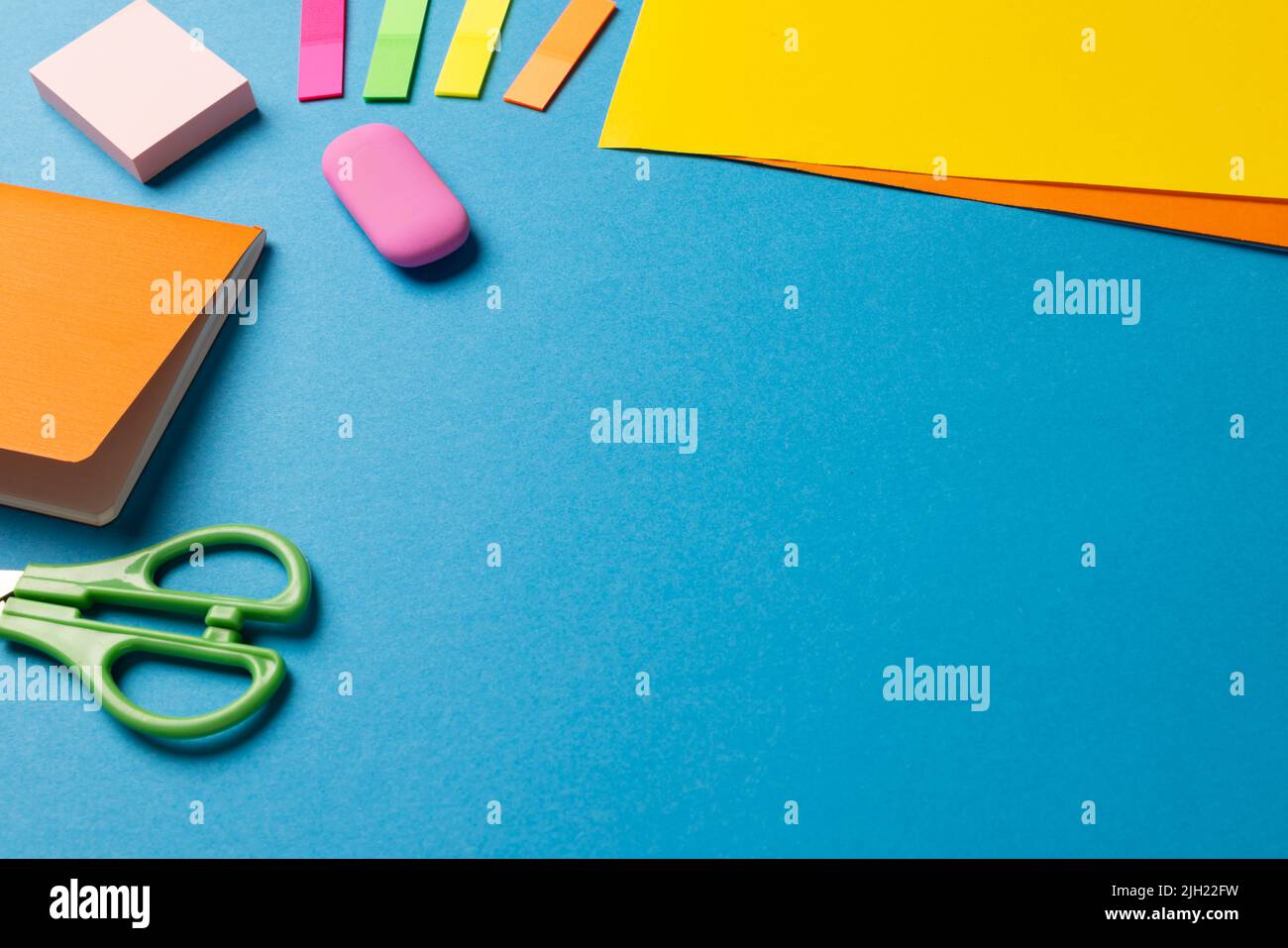 Composition of colorful school items with scissors and empty cards on ...