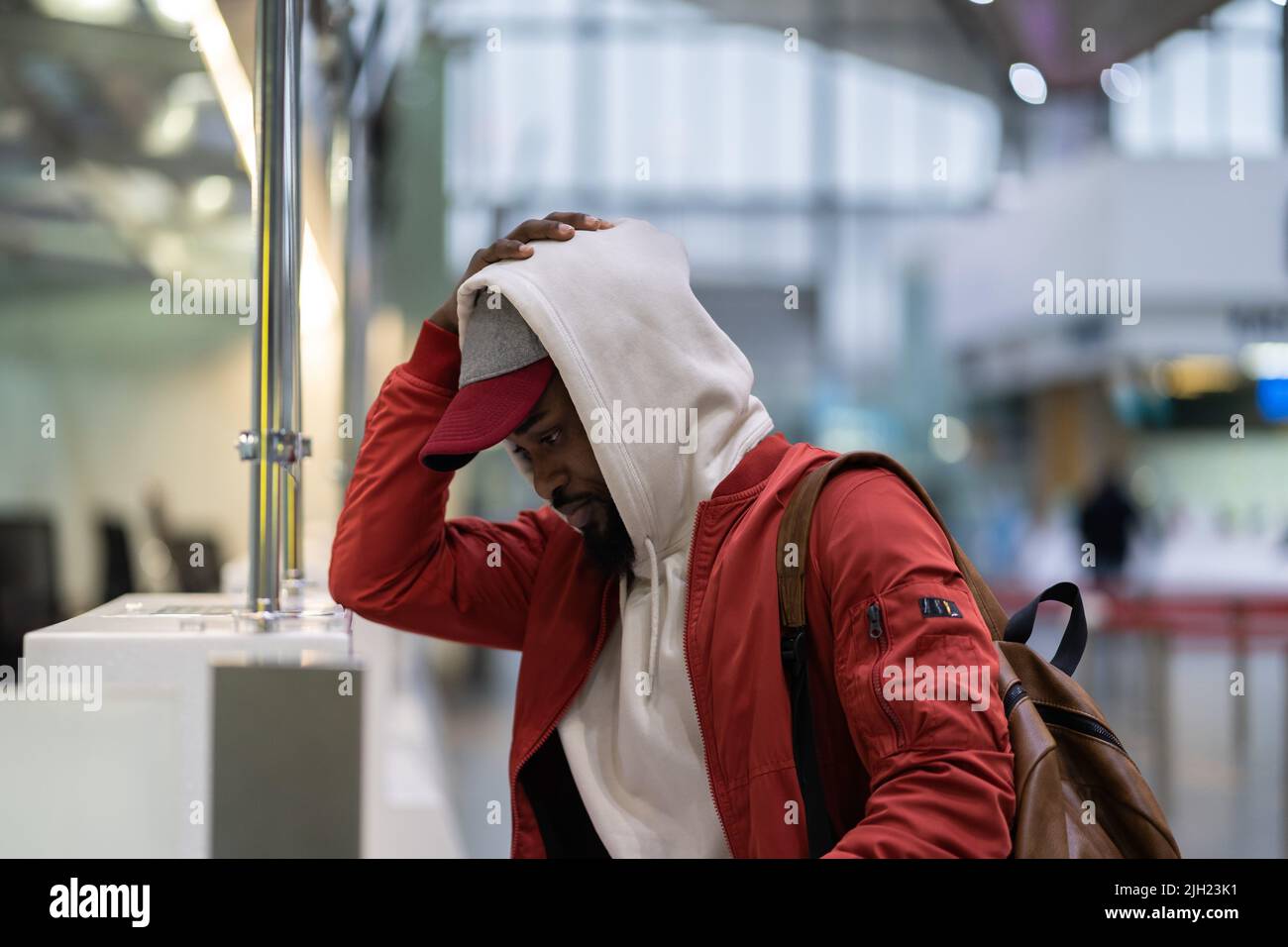 Frustrated sad young african man traveler missed flight standing at ...