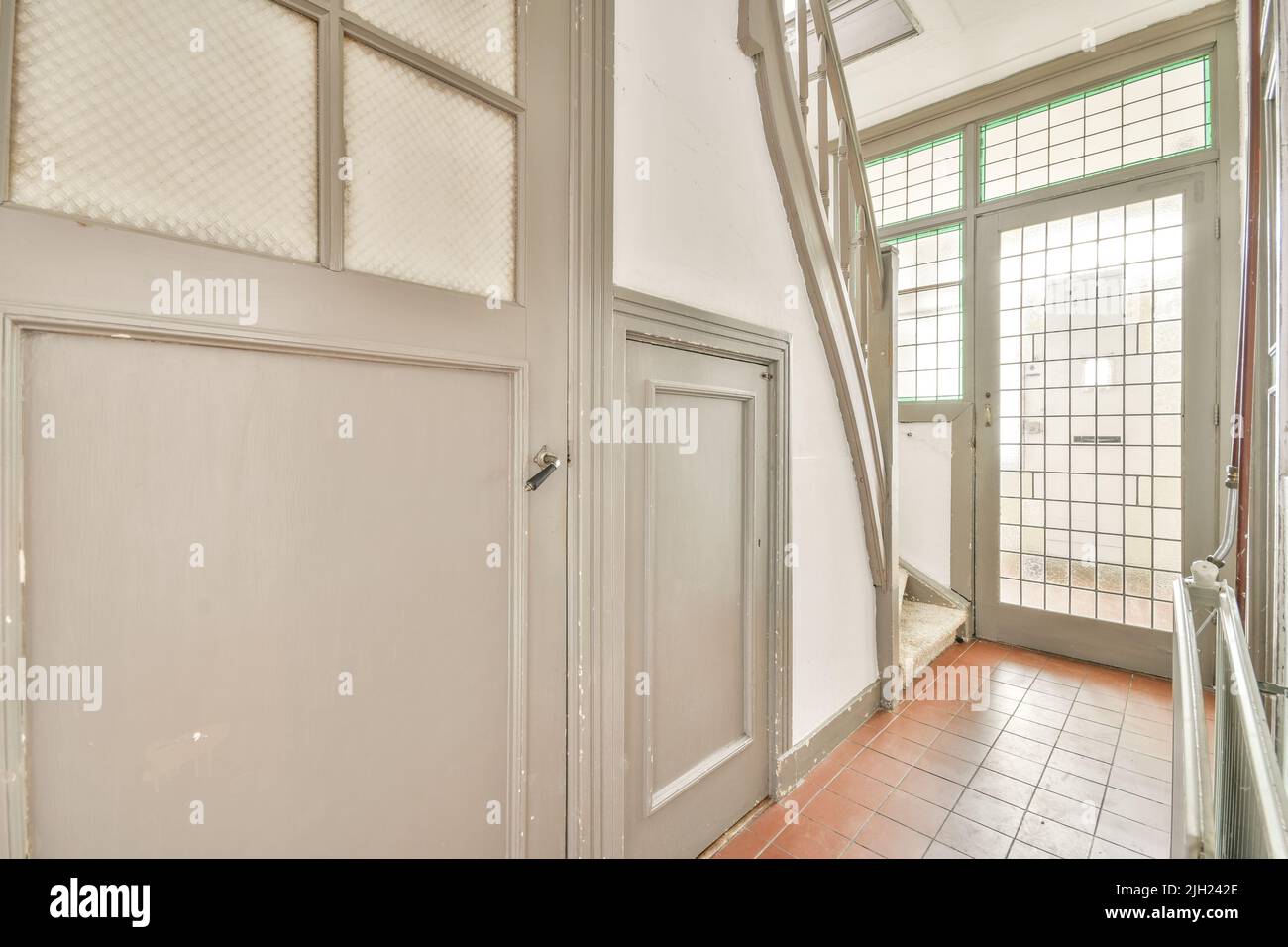 Light narrow hallway with many doors in white walls and glowing lamp ...