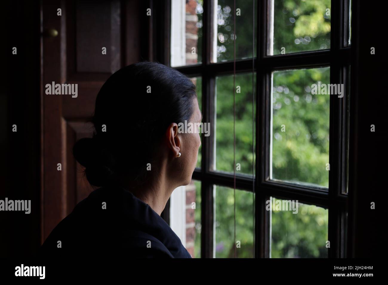 Admiring the outside from a window Stock Photo - Alamy