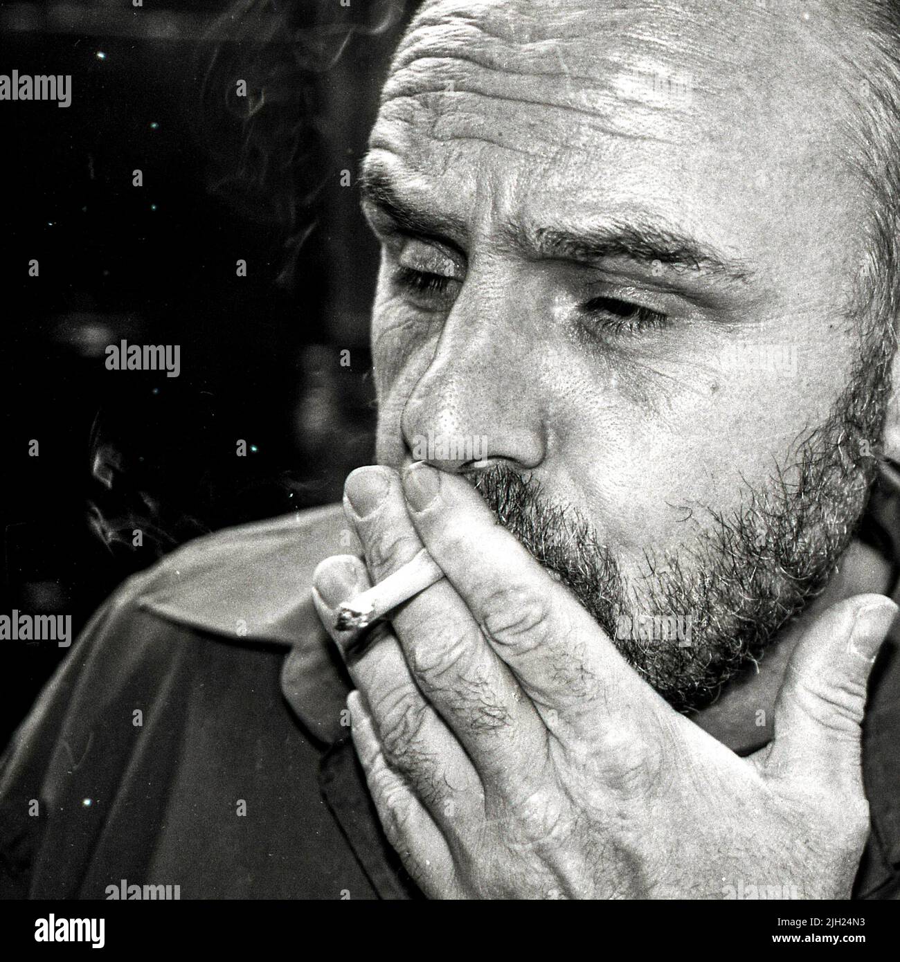 A man smokes a cigarette. Daily life in Saint-Malo. France Stock Photo ...