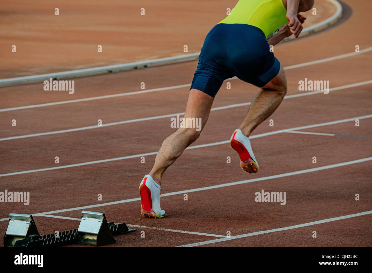 athlete running from start of sprint race Stock Photo - Alamy