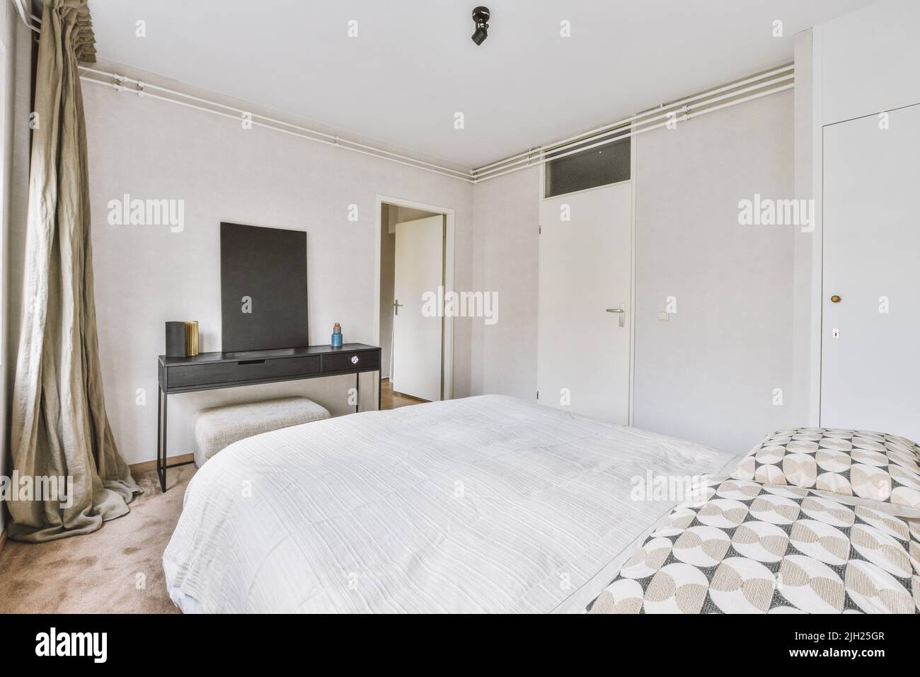 Home interior design of bedroom with bed and wooden wardrobe placed in ...