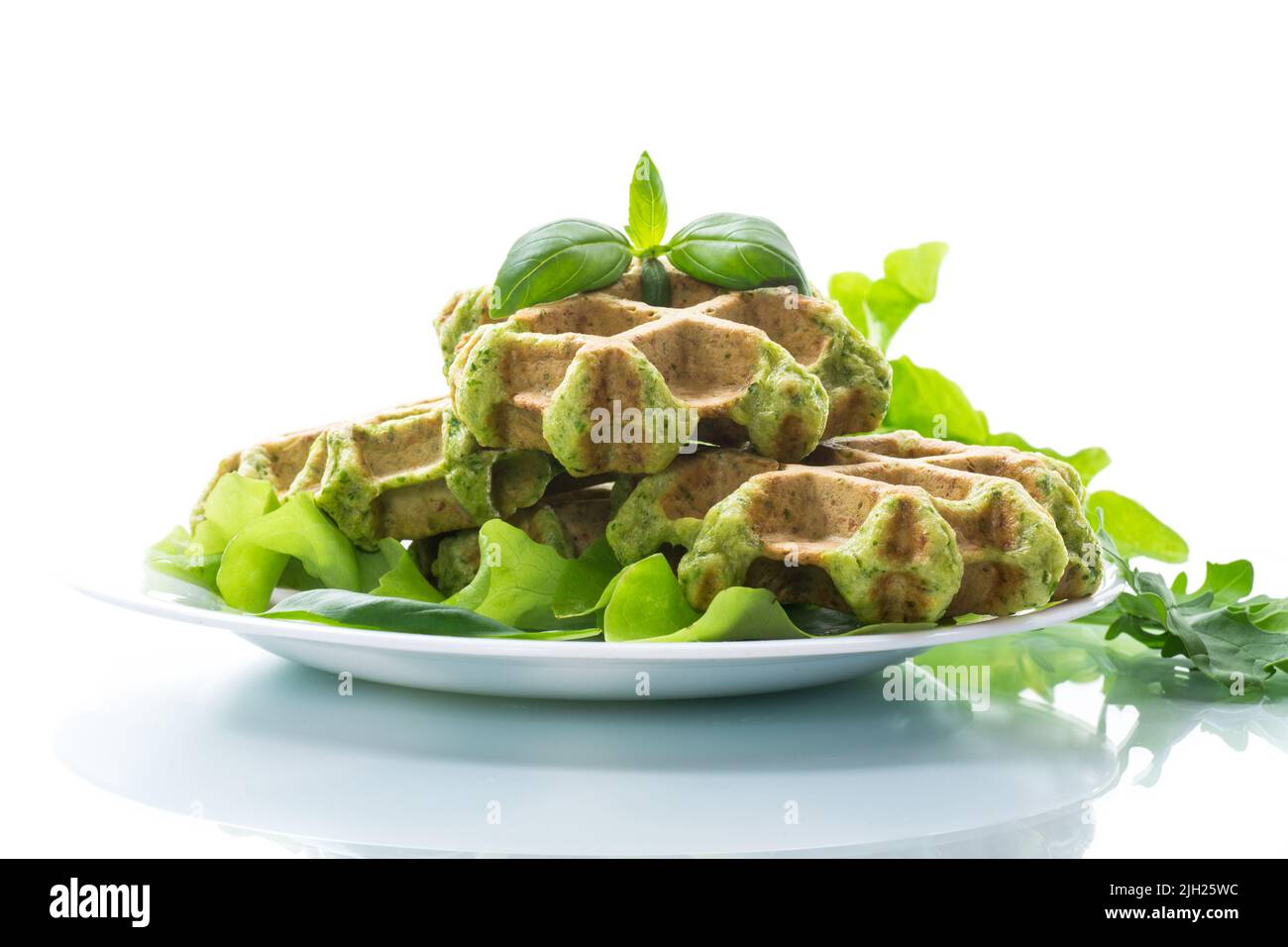 vegetable waffles cooked with herbs in a plate isolated on white ...