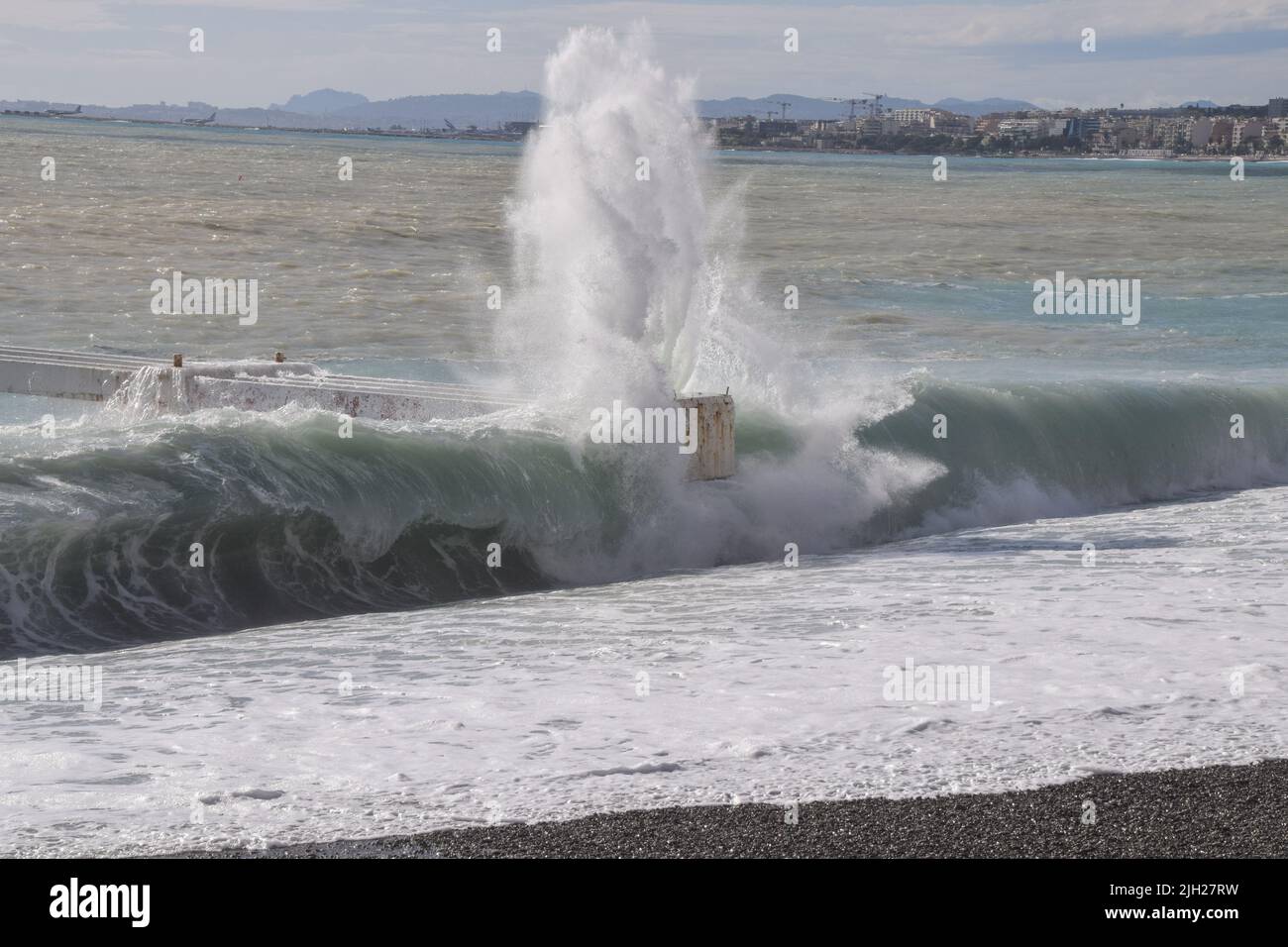 Waves smash against an old jetty in Nice, South of France Stock Photo ...