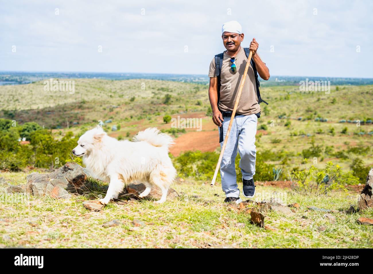 Middle aged hiker with dog or pet climbing mountain - concept of ...