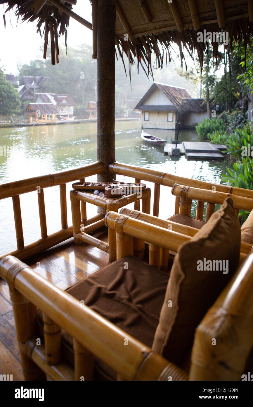 Two nice traditional brown bamboo chairs waiting for you to sit and ...