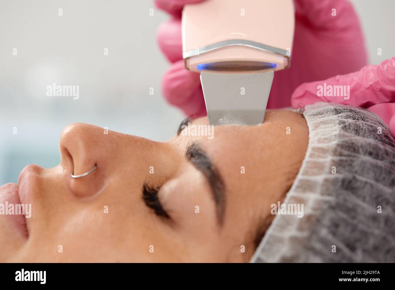 Beautiful woman receiving ultrasound cavitation facial peeling ...