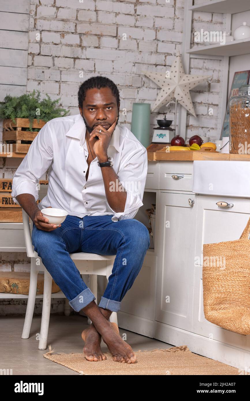 African American black man cooking breakfast or lunch on kitchen at ...