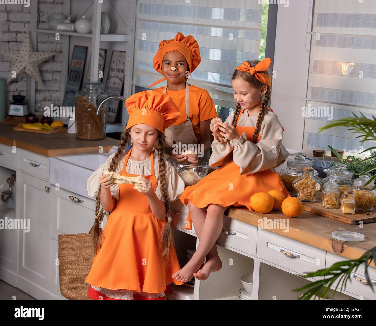 Happy children friends eating fresh orange and playing with fresh ...