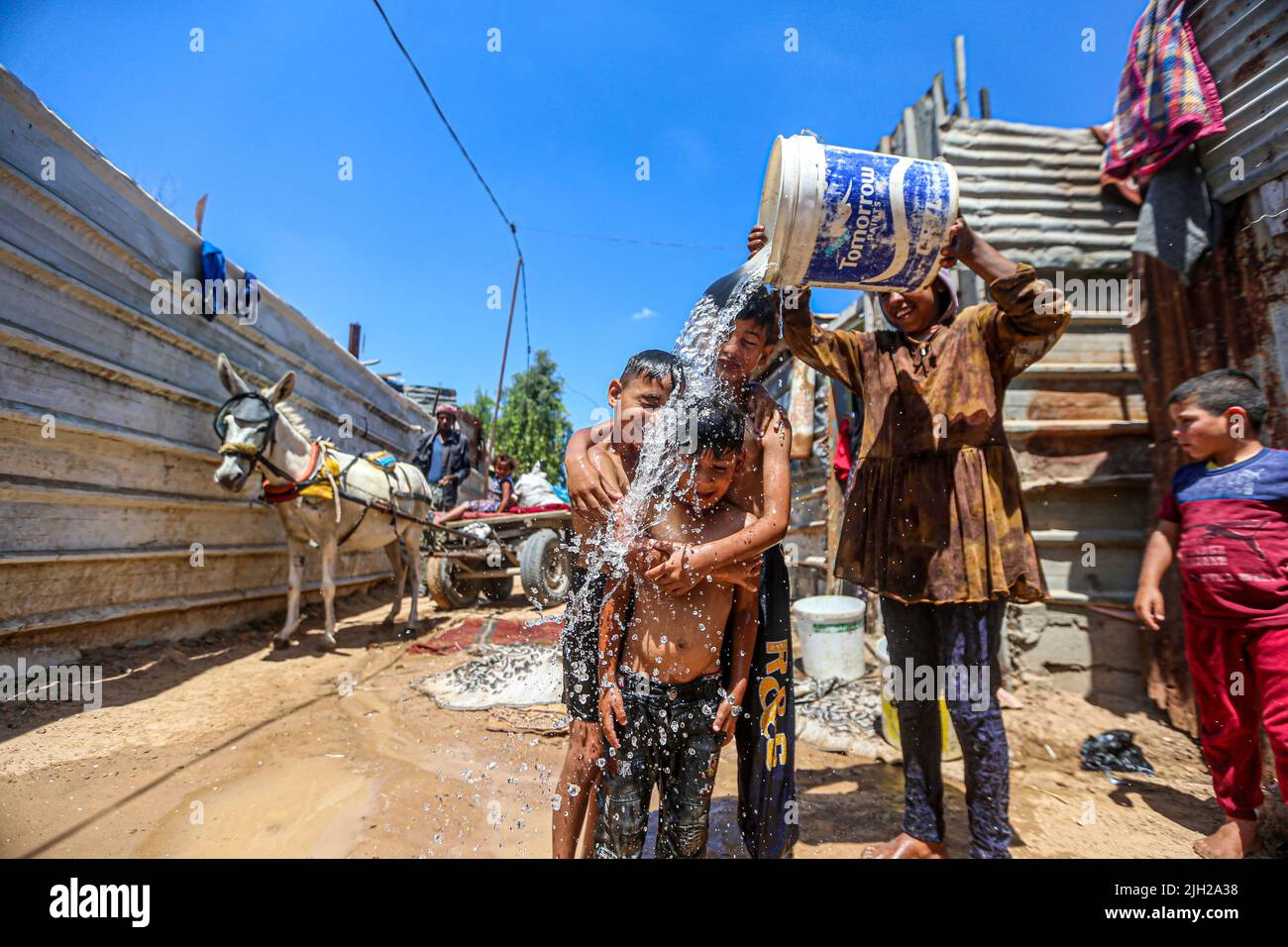 Gaza City, Palestine. 14th July 2022. A Palestinian mother showering ...
