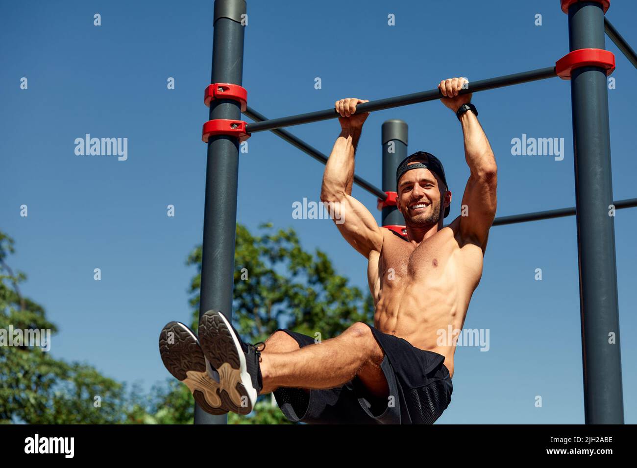 Strong man hanging from pull hi-res stock photography and images - Alamy