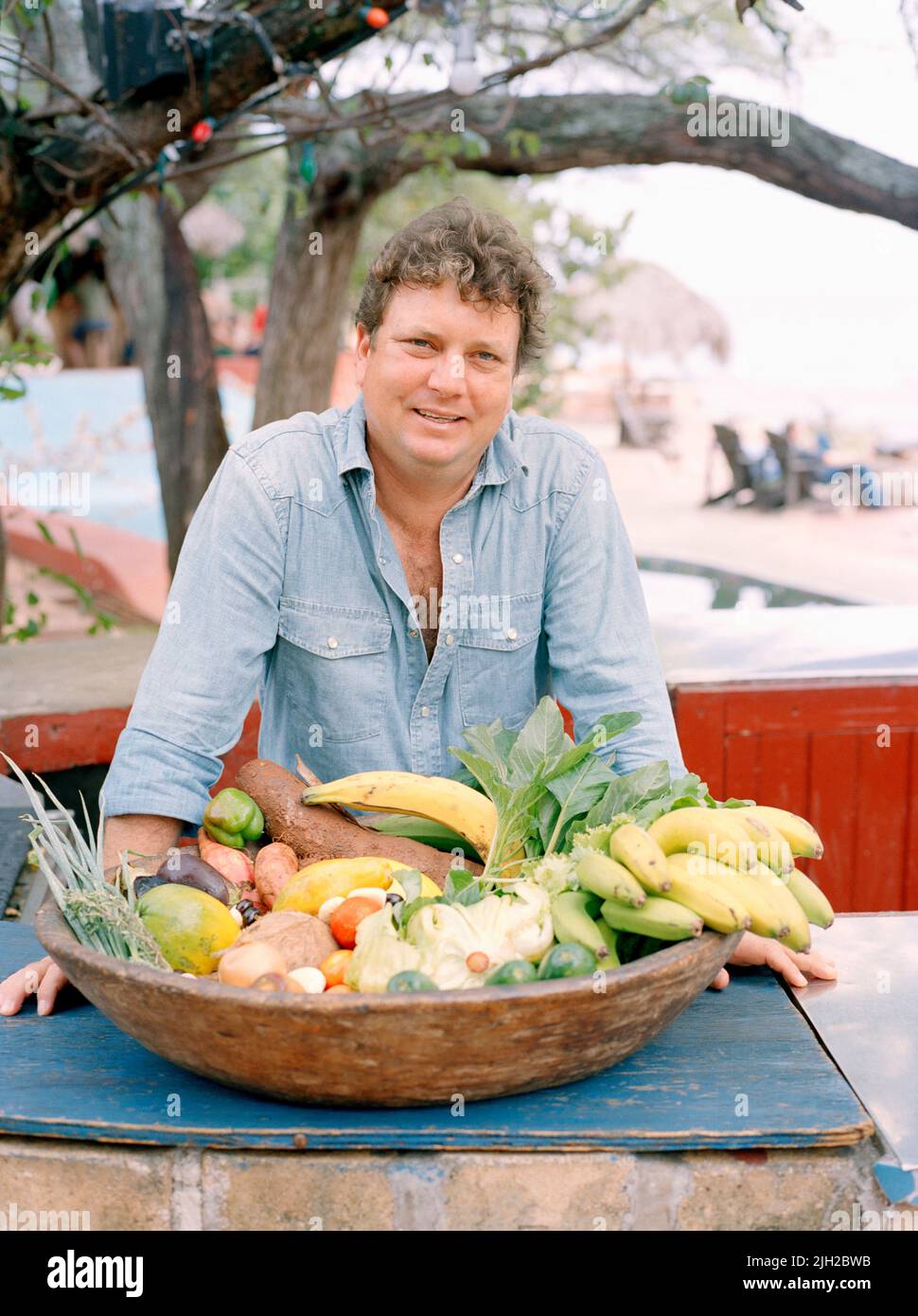 Jake's Resort owner Jason Henzell brings in a platter of organic fruits ...