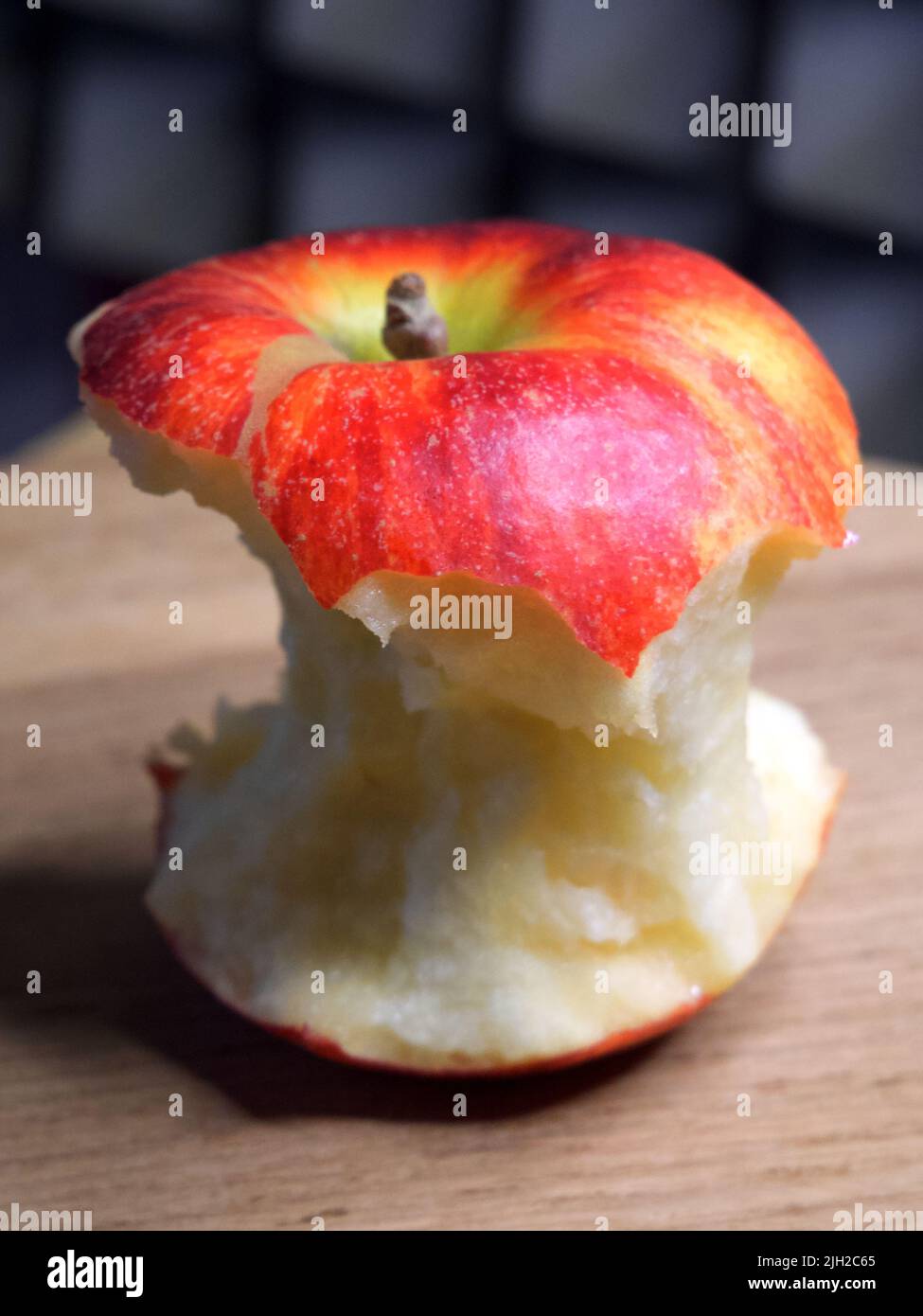 A bitten red apple, close-up shot. Apple core Stock Photo - Alamy