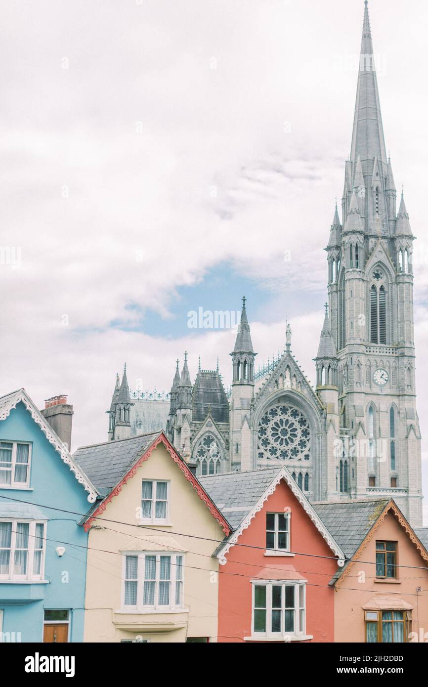 Row of colorful homes in front of cathedral in Cobh, Ireland Stock ...