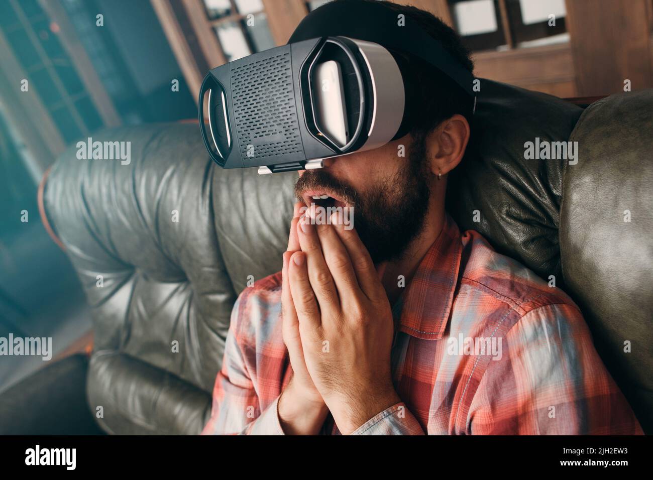 Shocked man with virtual reality glasses Stock Photo - Alamy