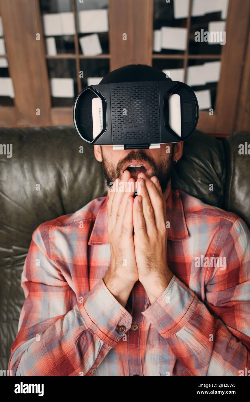 Shocked man with virtual reality glasses Stock Photo - Alamy