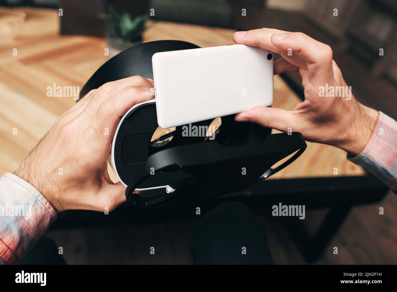 Hands put smartphone to vr headset Stock Photo - Alamy