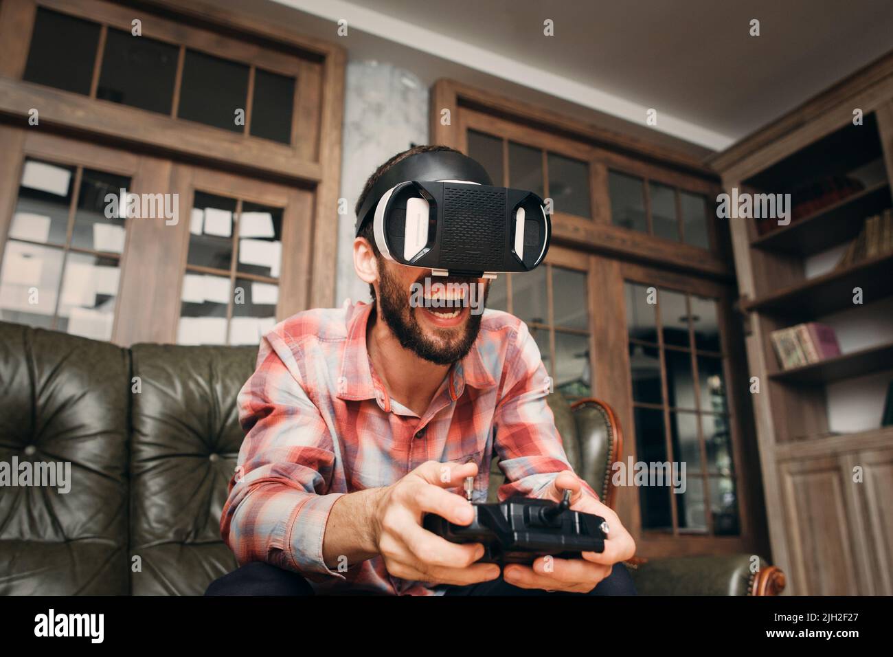 Excited man playing video game in vr glasses Stock Photo - Alamy