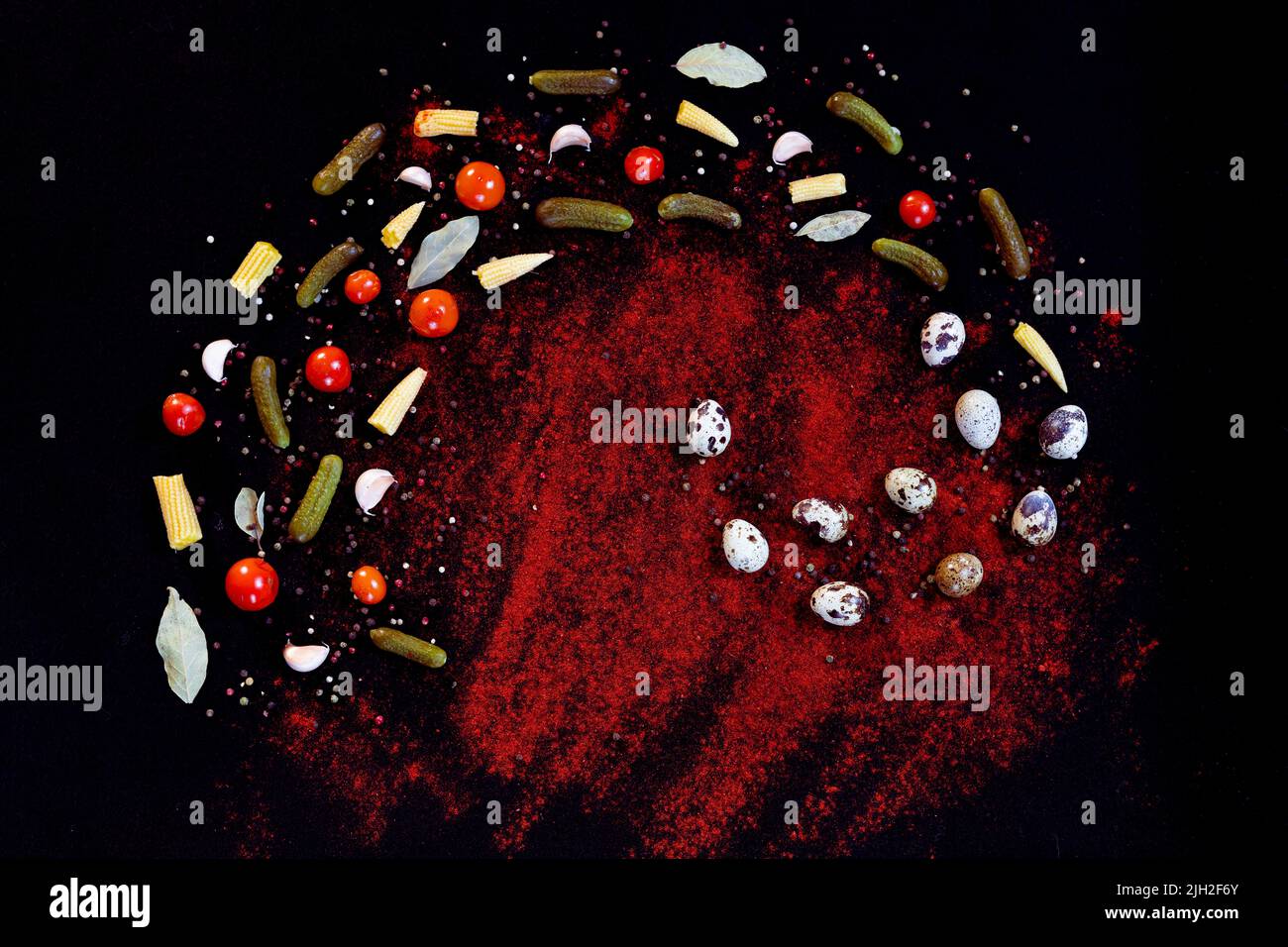 Small canned vegetables in the shape of a galaxy on a black background ...