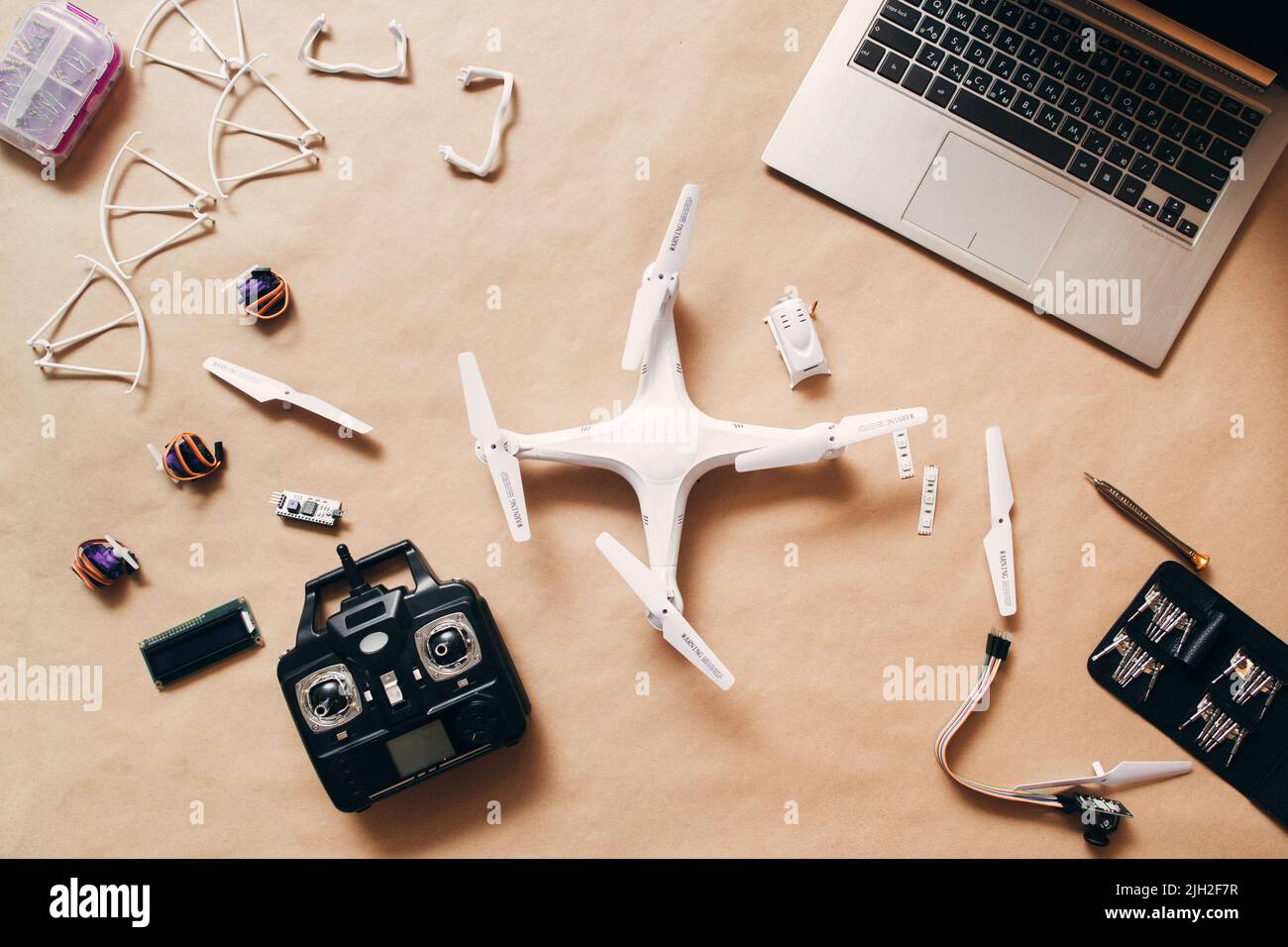 Drone with remote control and laptop, flat lay Stock Photo - Alamy