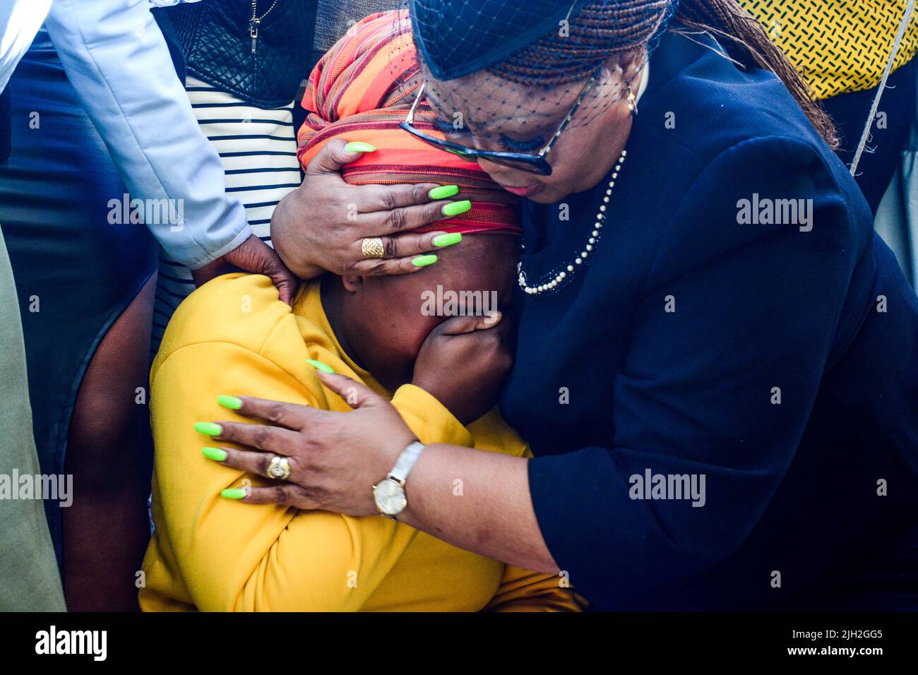 SOWETO, SOUTH AFRICA – JULY 14: A wWoman is conforted at the memorial ...