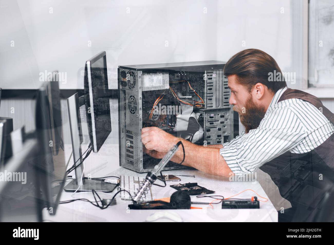 Repairman fixing computer, double exposure Stock Photo - Alamy