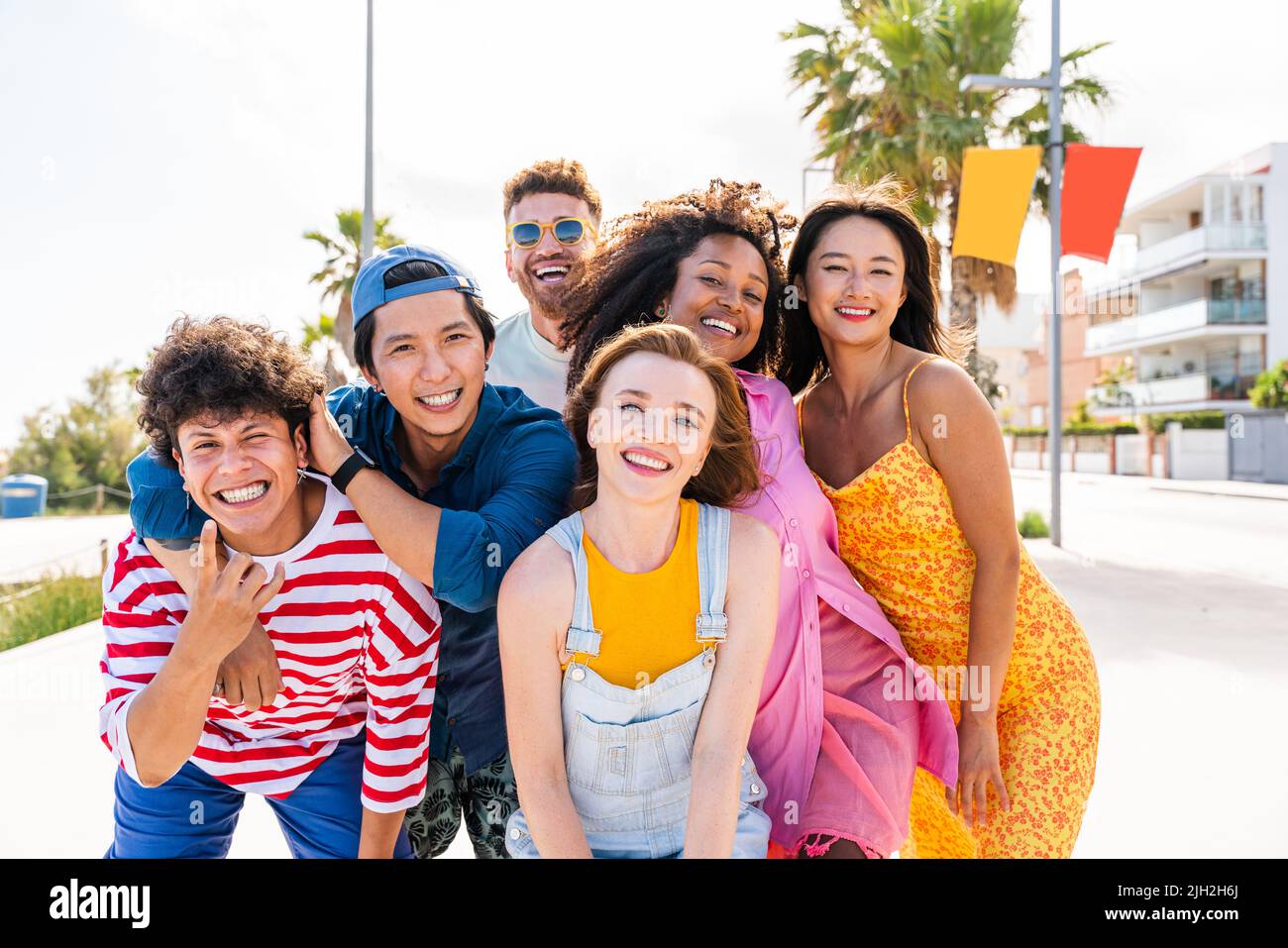 Multiethnic group of young happy friends bonding outside, having fun on ...