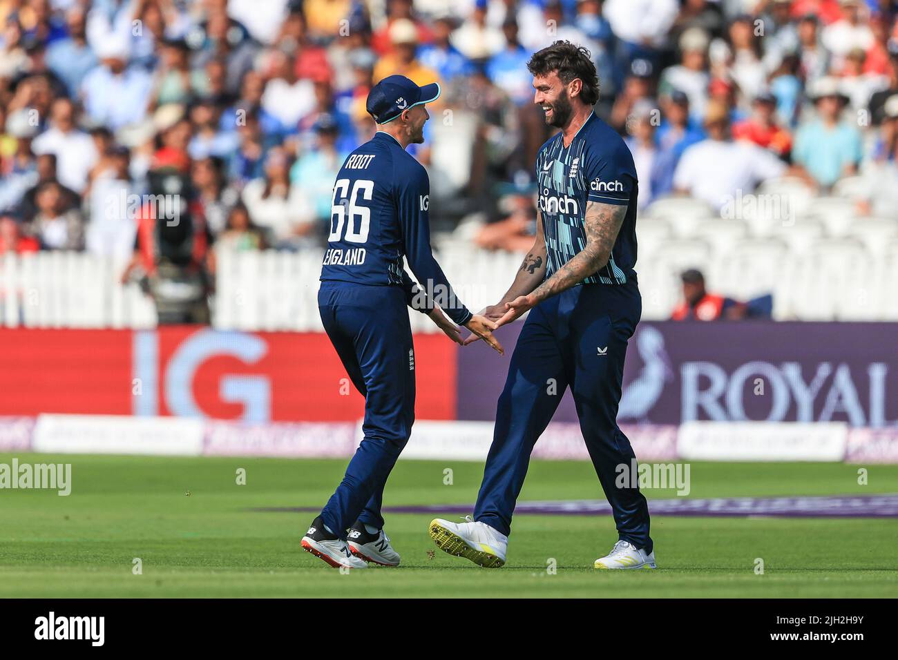 Reece Topley of England and Joe Root celebrate the wicket of Rohit ...