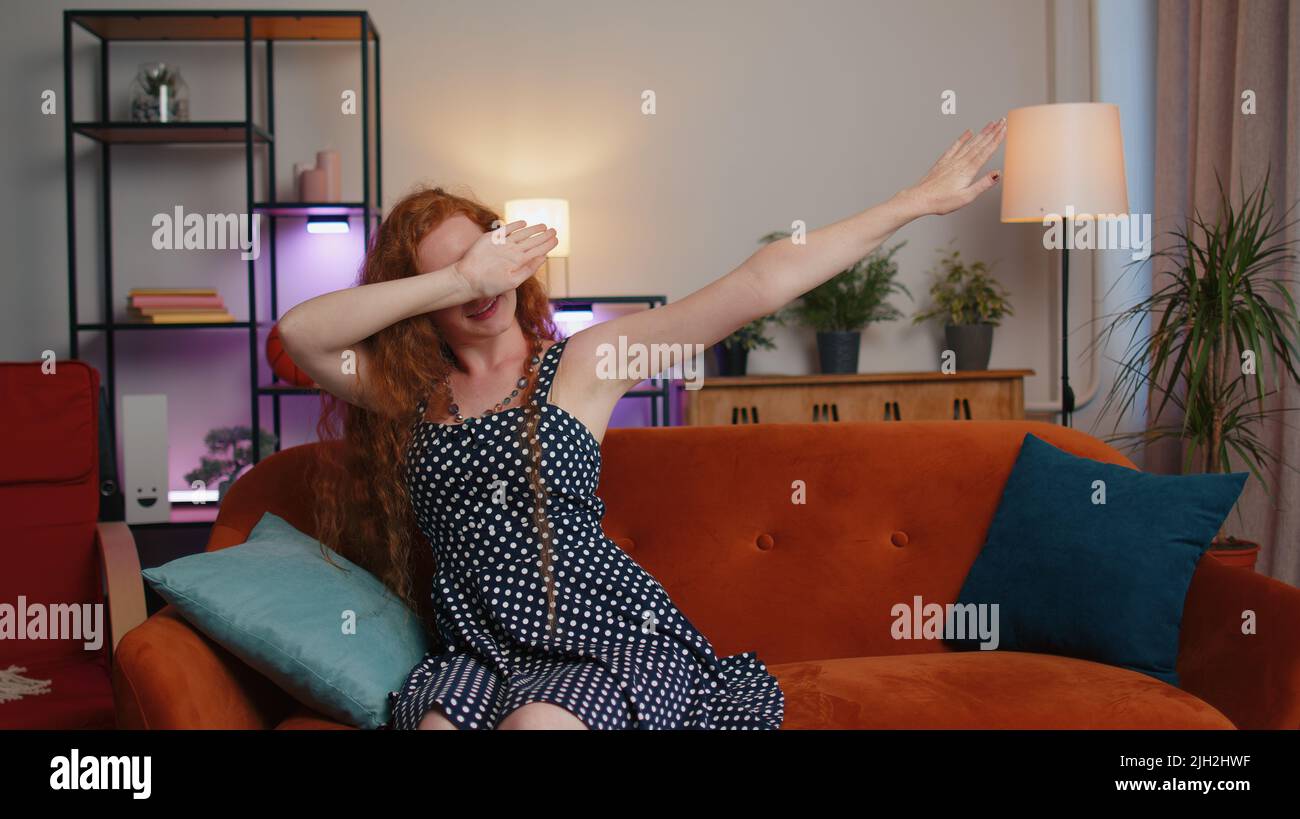 Trendy cheerful positive redhead young woman having fun dancing, moving ...