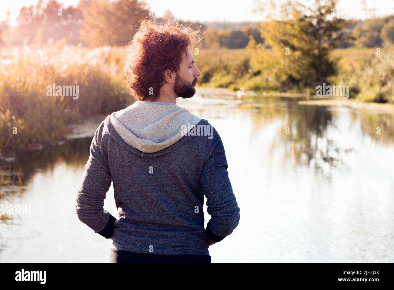 Back of man looking at river, free space Stock Photo - Alamy