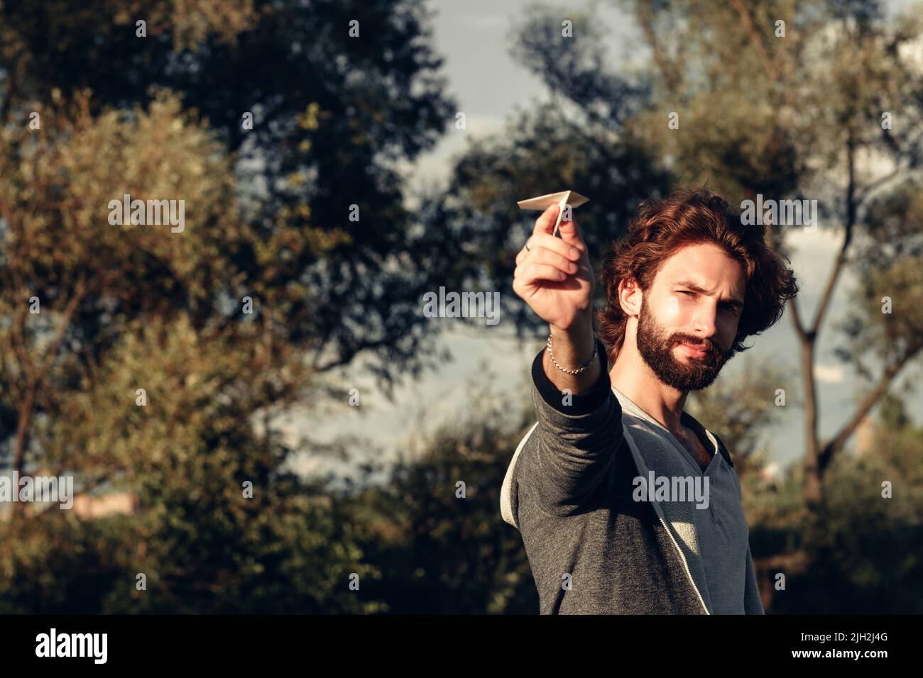 Man aiming paper airplane to camera free space Stock Photo - Alamy