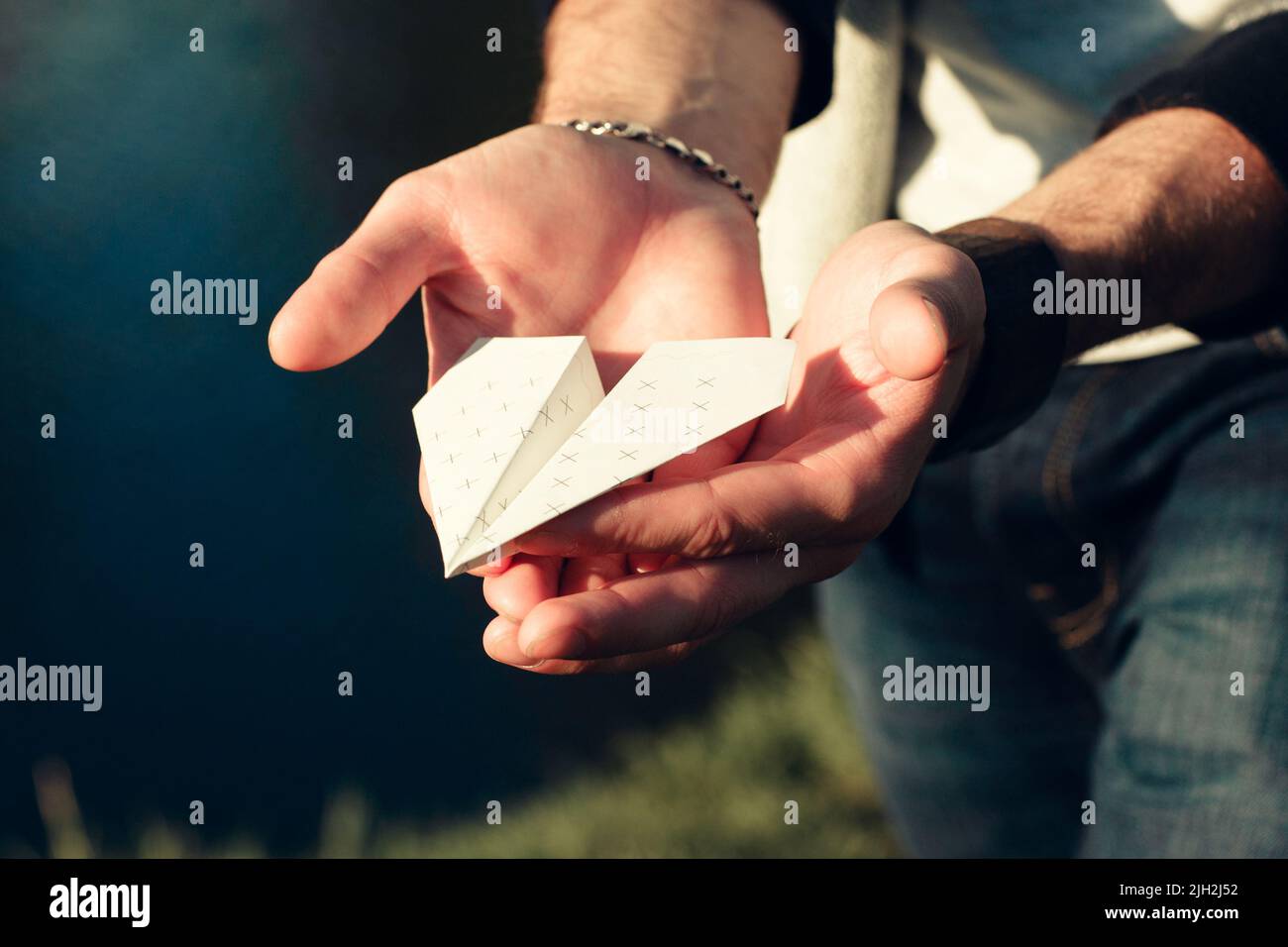 Hand holding paper plane close up hi-res stock photography and images ...