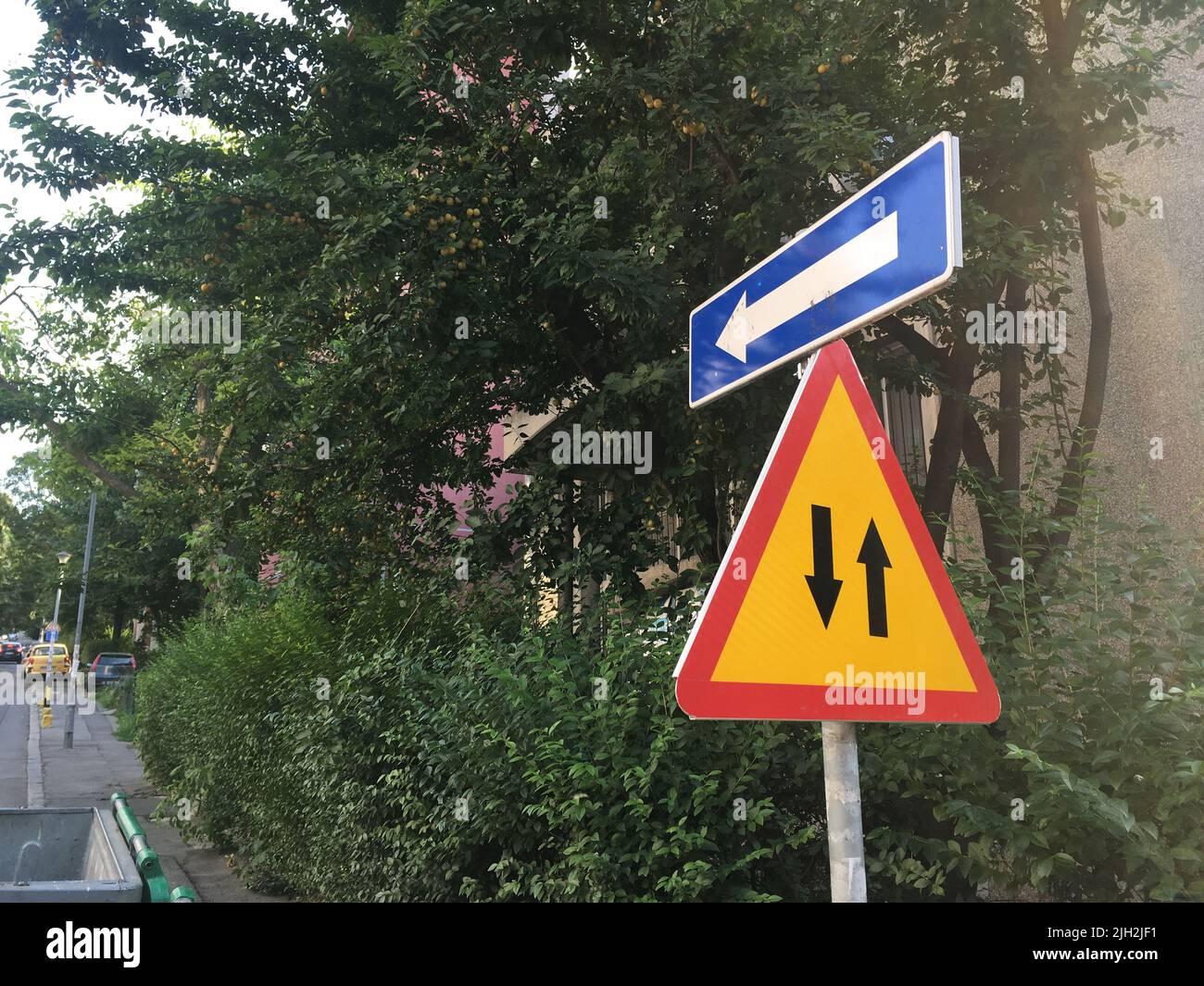 one way street traffic sign and two ways street traffic sign on a same ...