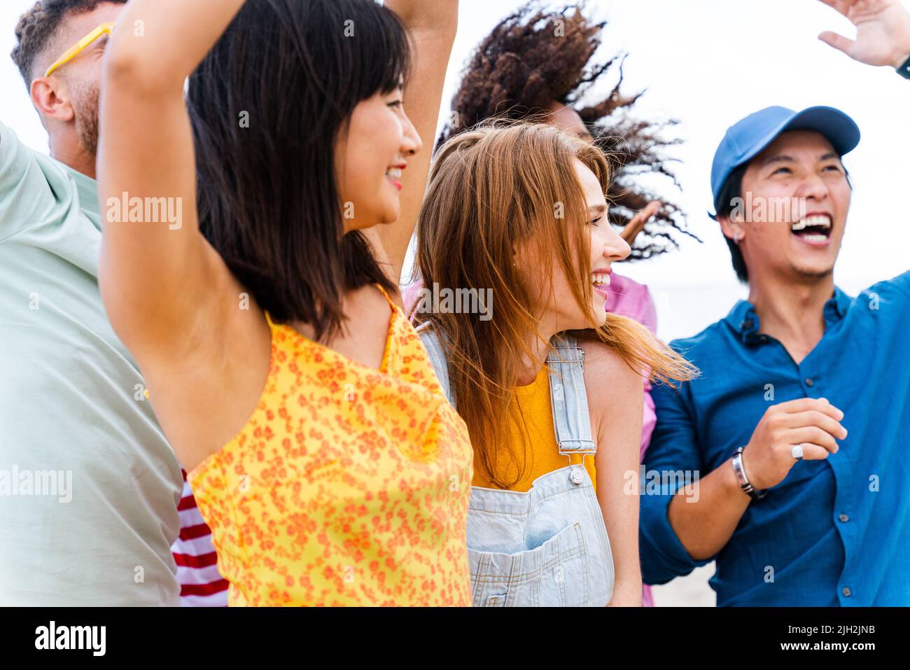 Multiethnic Group Of Young Happy Friends Bonding Outside Having Fun On