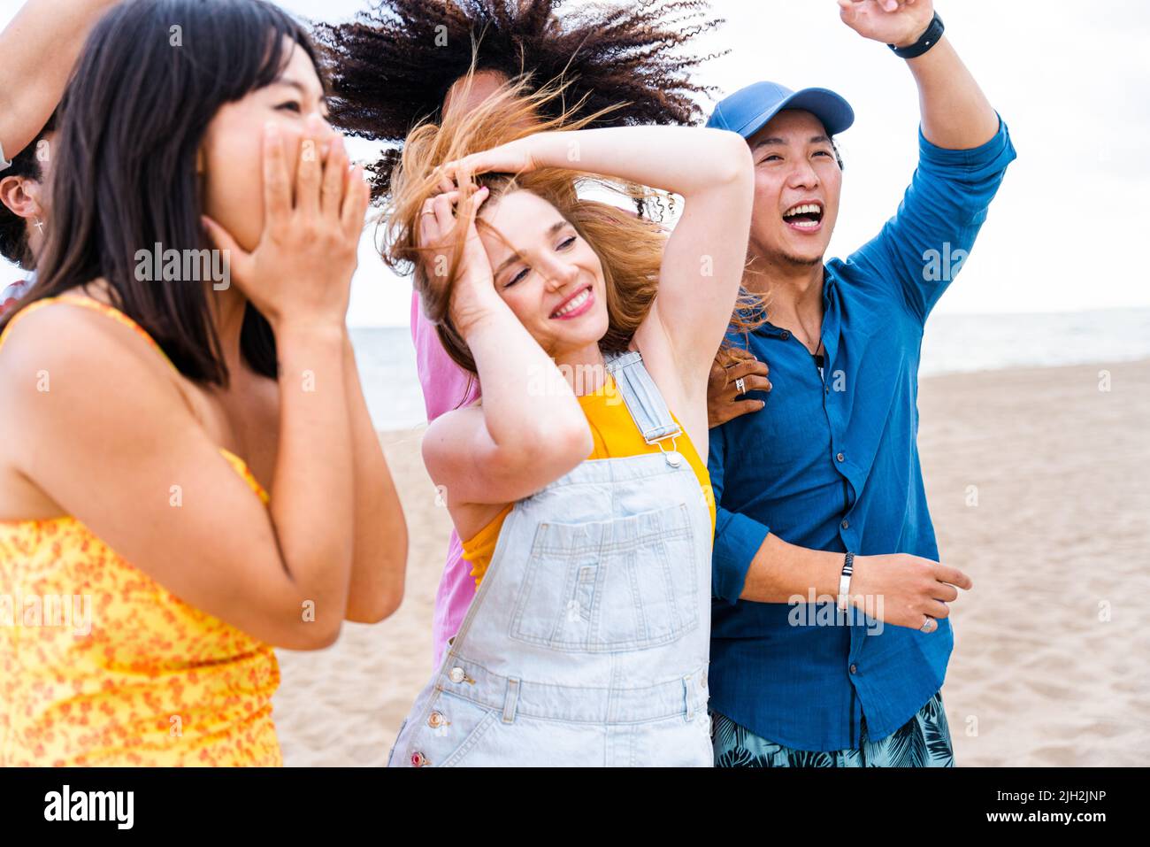 Multiethnic Group Of Young Happy Friends Bonding Outside Having Fun On