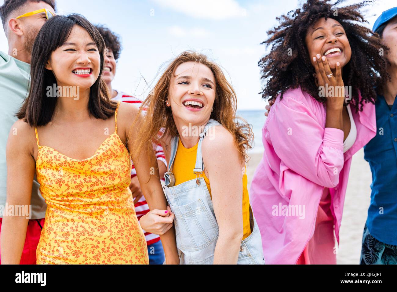 Multiethnic Group Of Young Happy Friends Bonding Outside Having Fun On