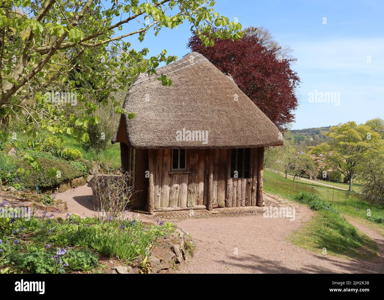 An quaint hut with a thatched roof looks out over the English ...