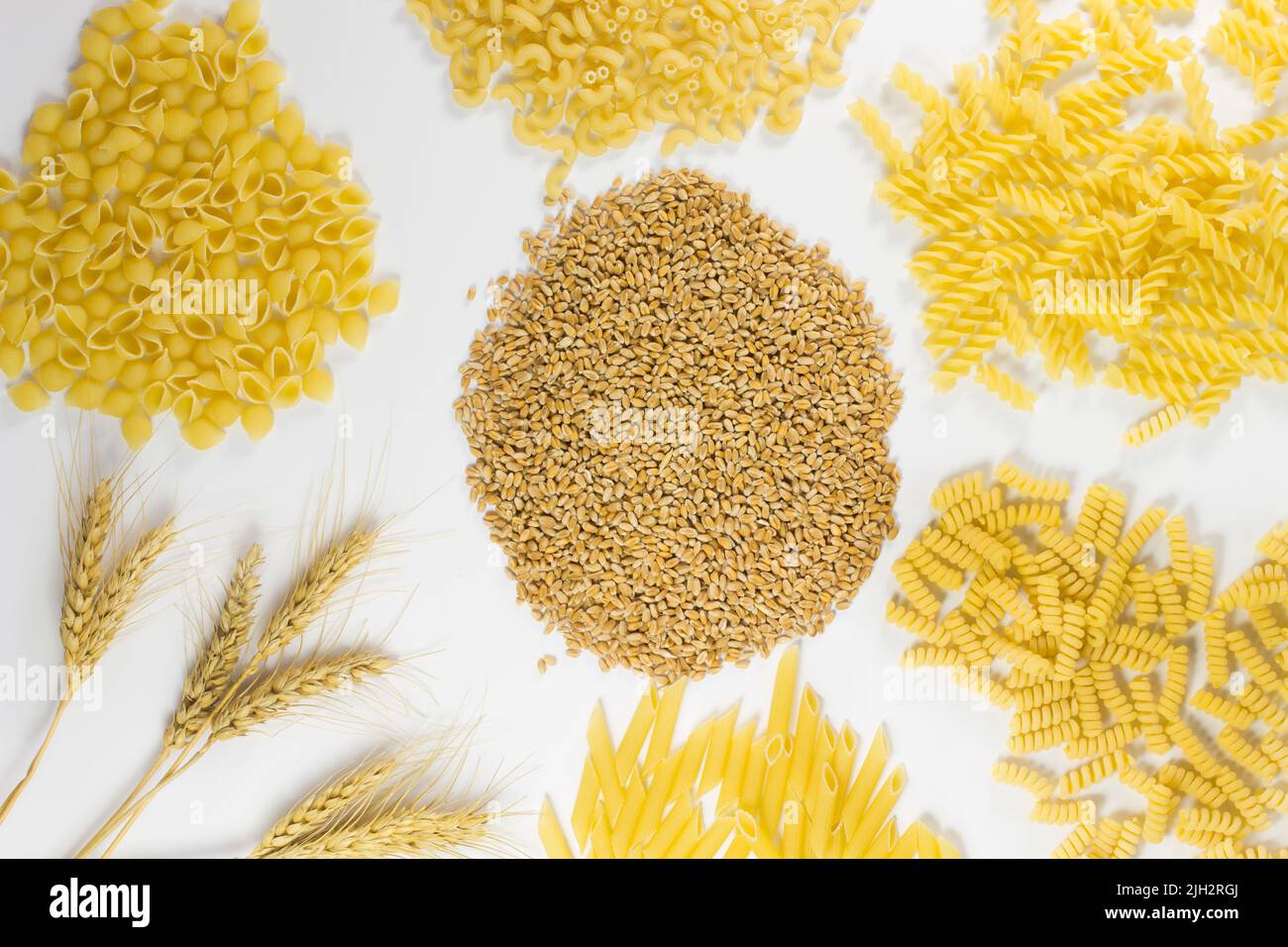 Different kinds of pasta. Grains of wheat and wheat spikelets. Top View ...