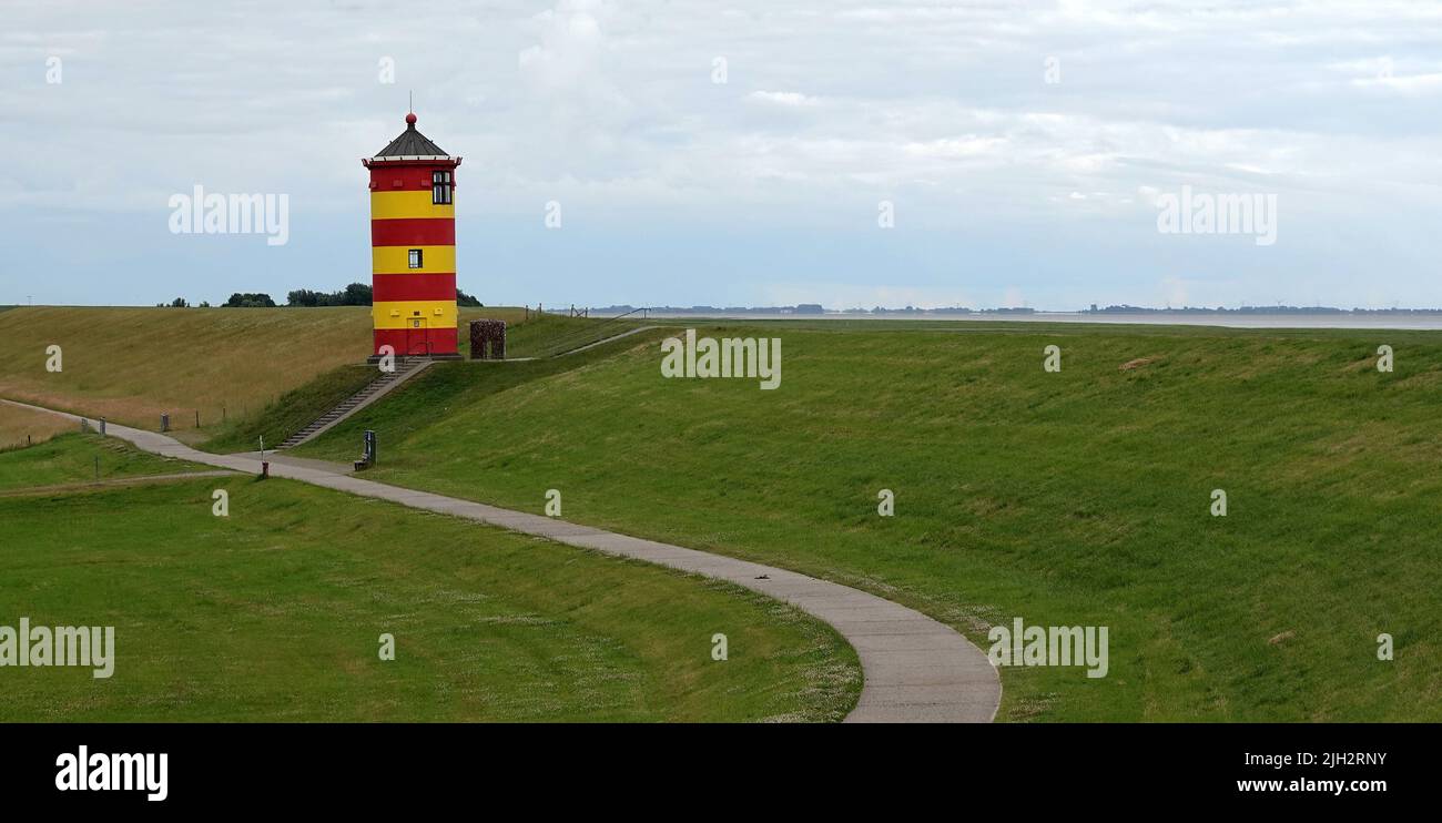 Cute German lighthouse in red and yellow. It's build in 1891 and 11 ...