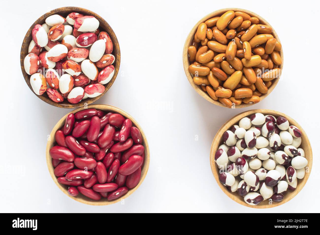 Four kinds of beans on white background. Top view Stock Photo - Alamy