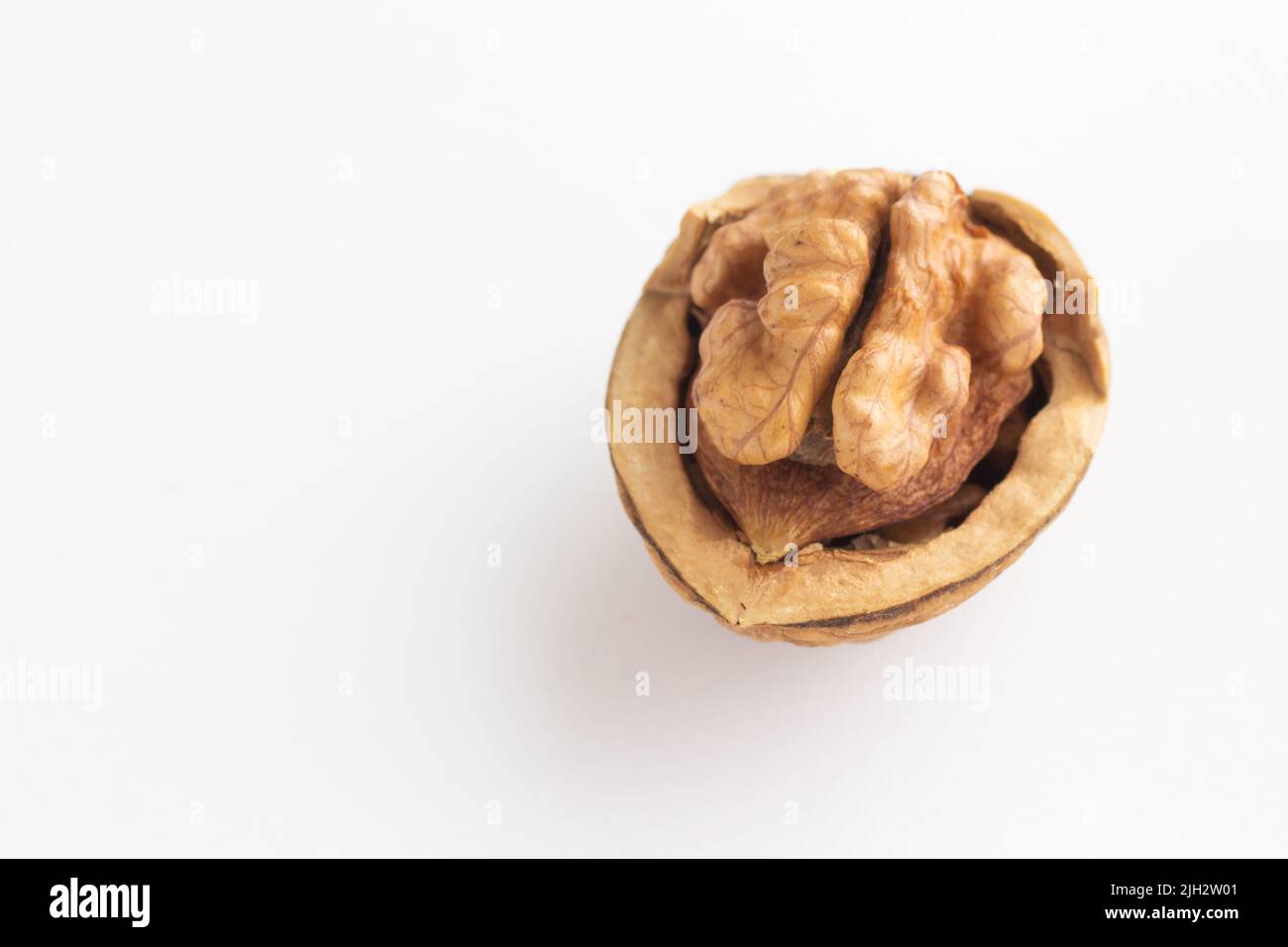 Half of a walnut on a white background Stock Photo - Alamy